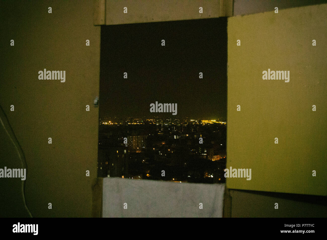 Metropolis skyline from the window of a vertical slum Stock Photo - Alamy