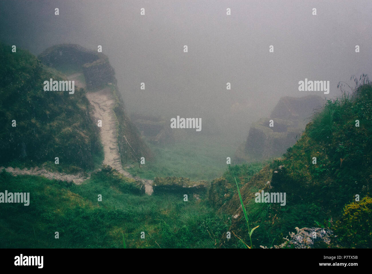 Historical ruins of the ancient Inca civilization covered by fog at ...