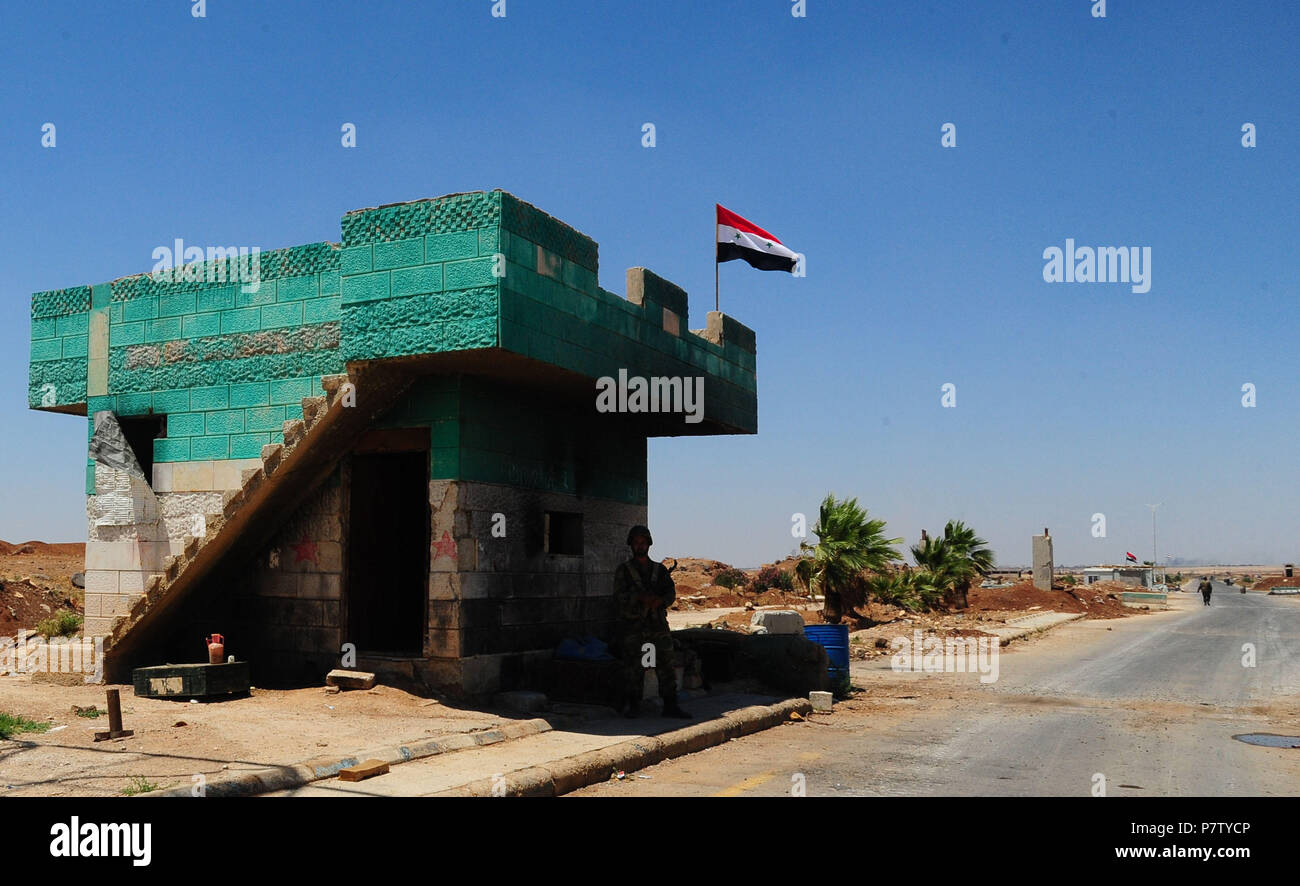 Daraa, Syria. 7th July, 2018. A Syrian flag is seen on a military post ...