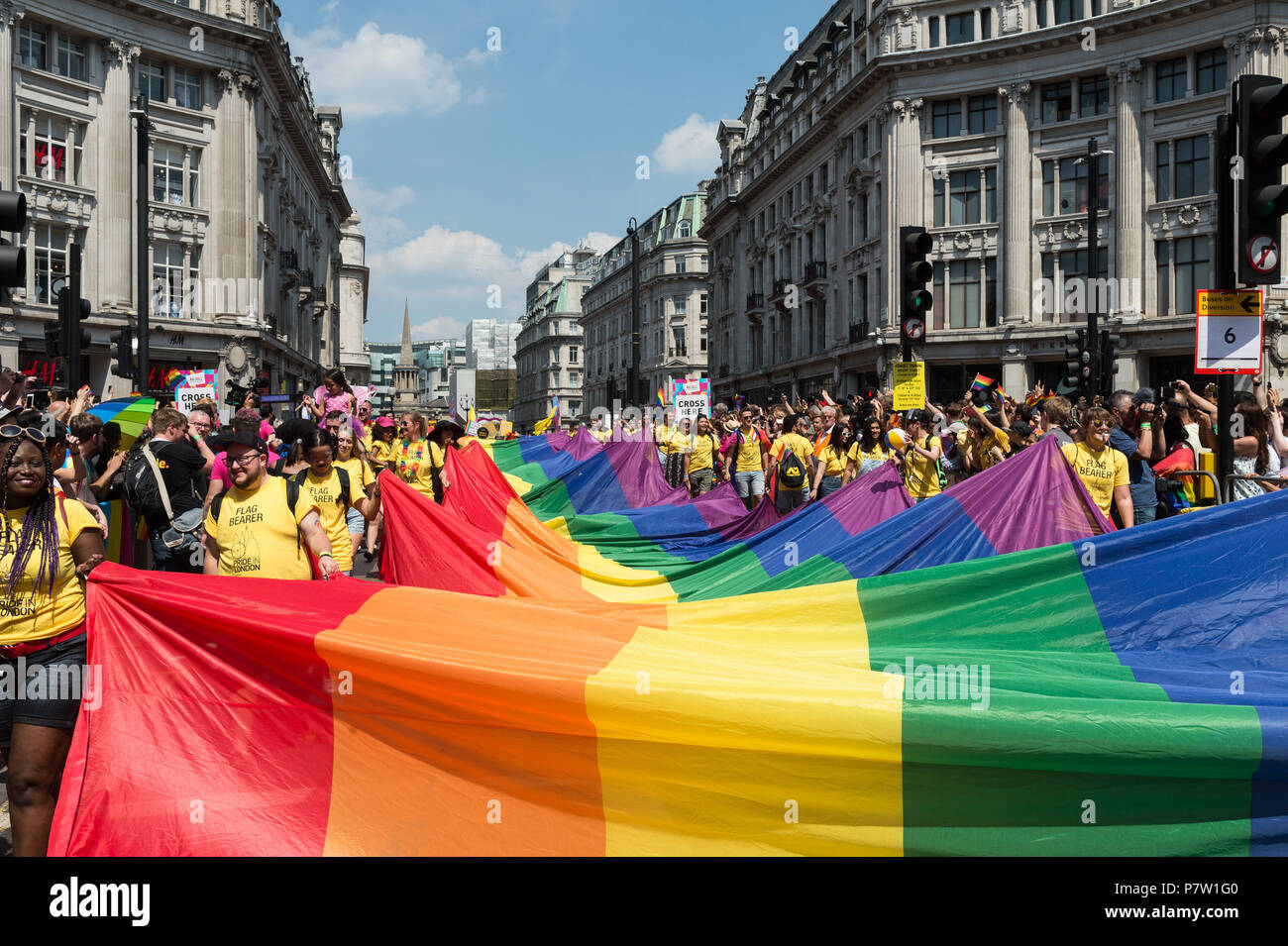 London, UK. 7th July, 2018. Flagbearers carry a rainbow flag during ...