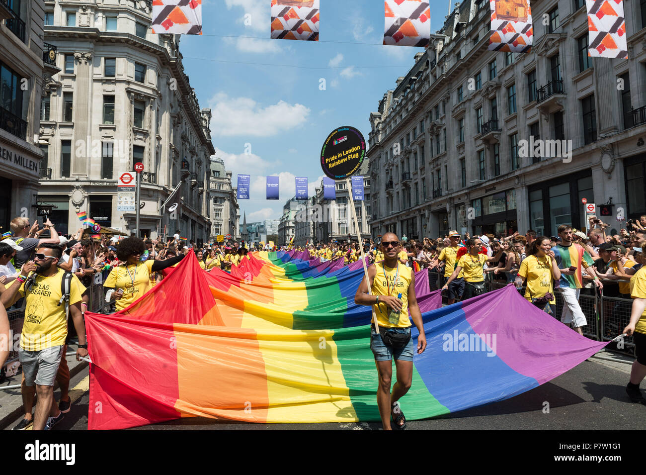 London, UK. 7th July, 2018. Flagbearers carry a rainbow flag during ...