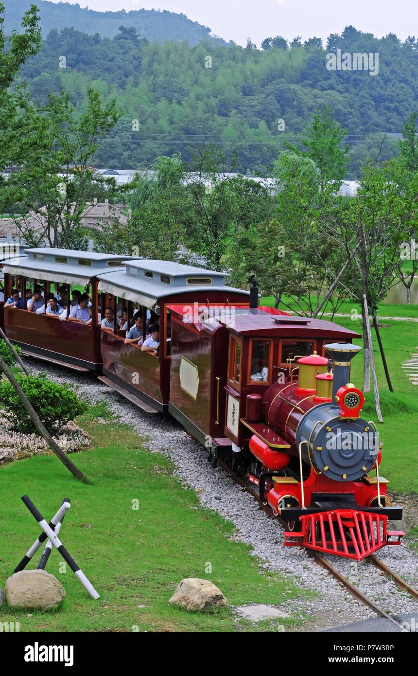 Anji, China's Zhejiang Province. 7th July, 2018. Tourists ride a train ...