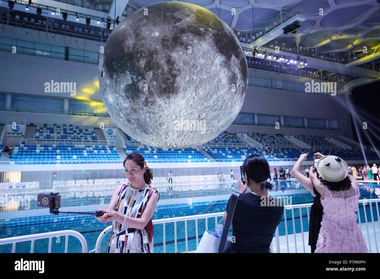 Beijing, China. 8th July, 2018. Visitors take photos of a huge moon ...