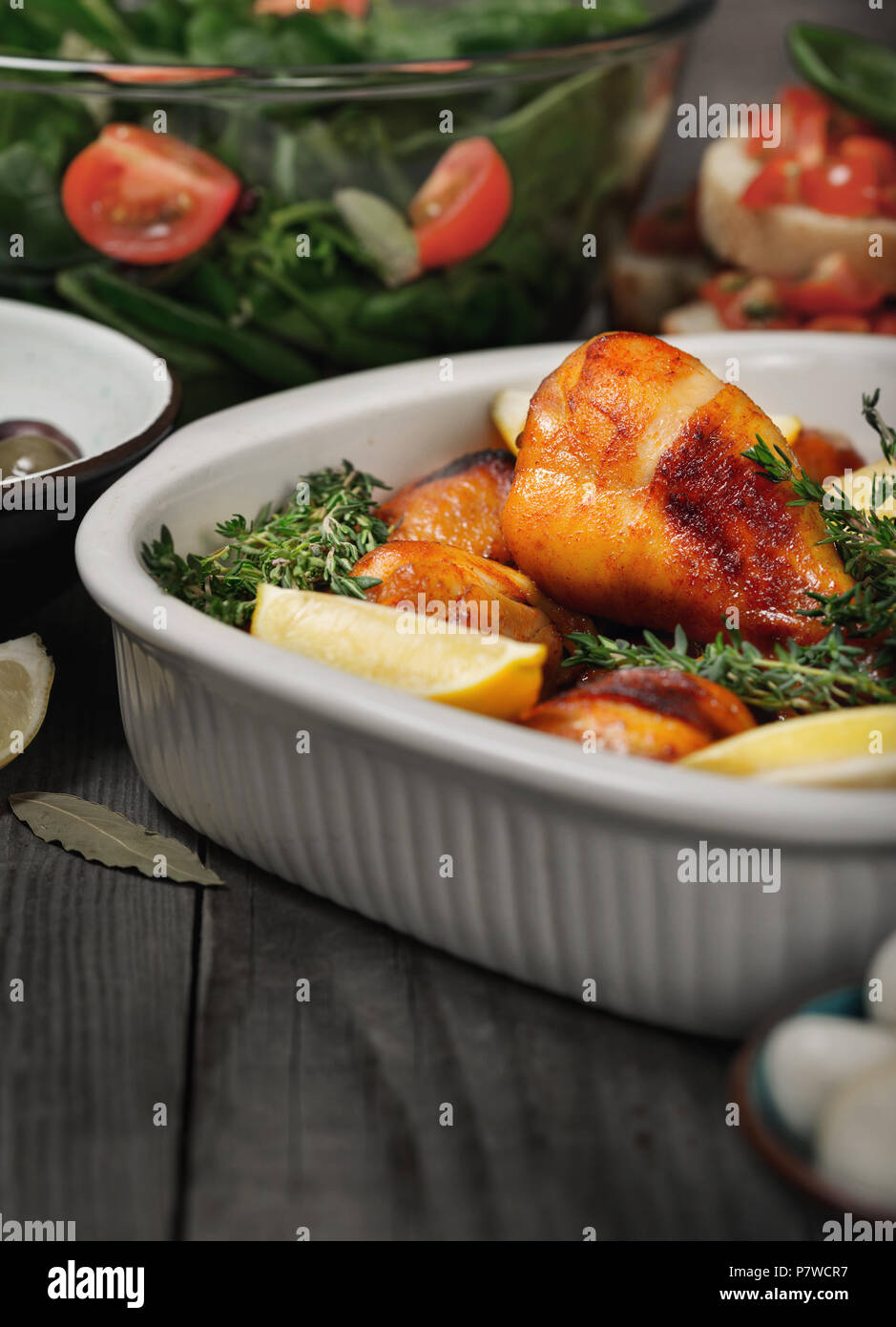 Baked chicken legs with a juicy crust on a wooden table Stock Photo - Alamy