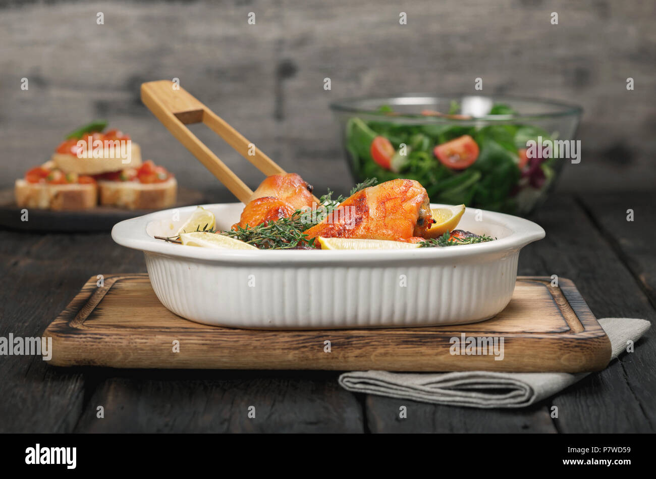 Baked chicken legs with a juicy crust on wooden table Stock Photo - Alamy