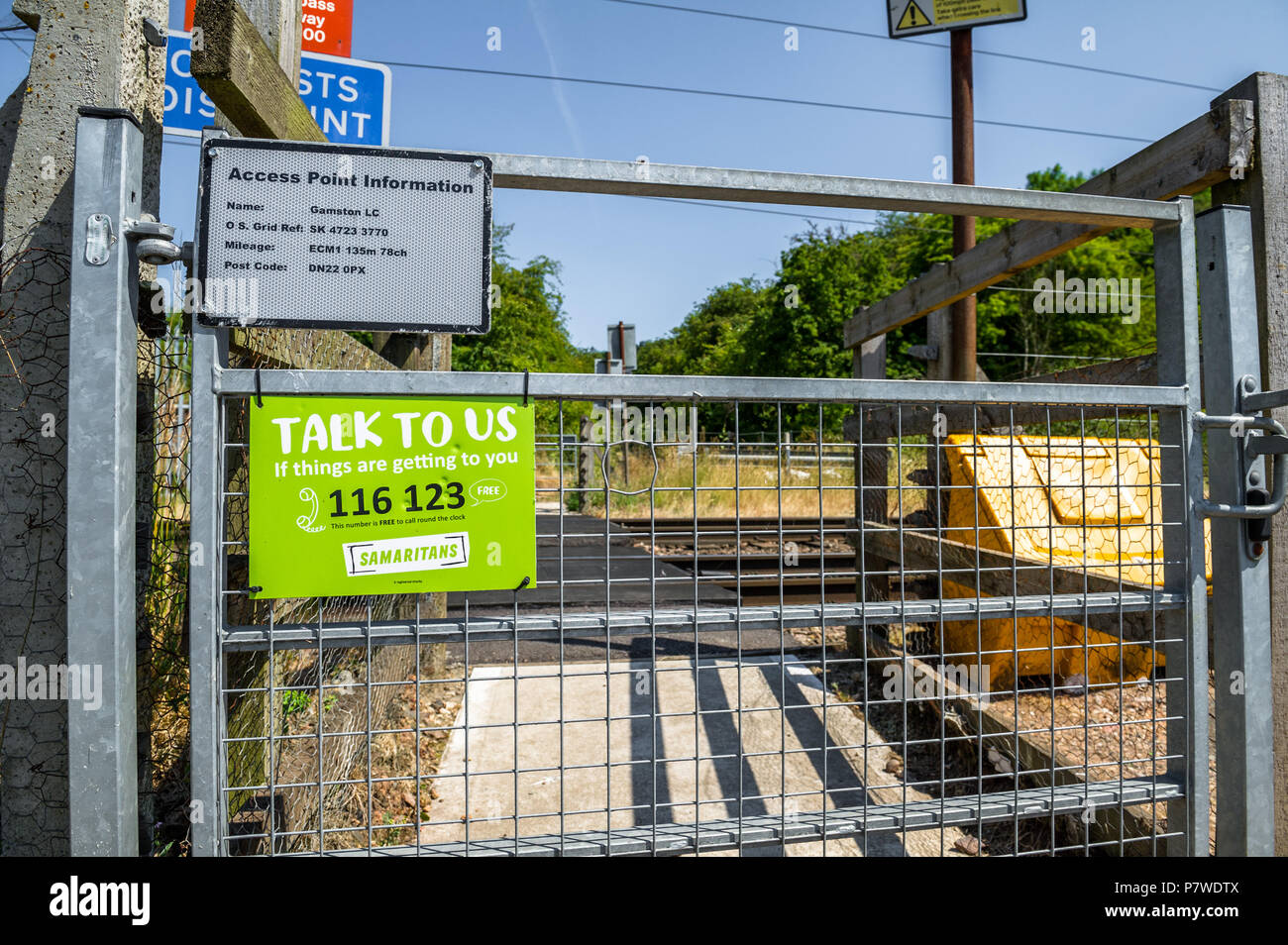 Samaritans notice 'talk to Us' at a level crossing footpath on the East ...