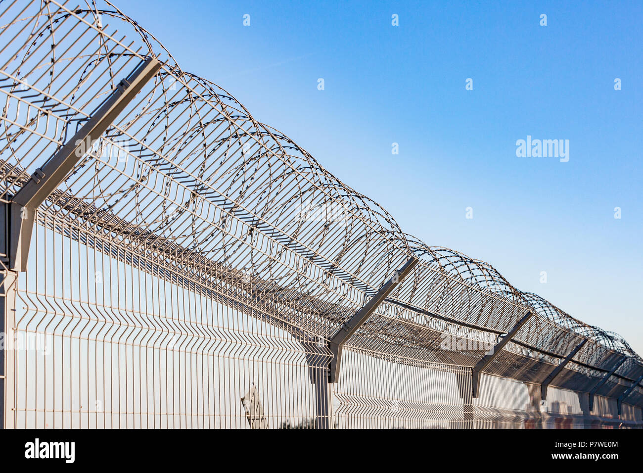 Security with a barbed wire fence Stock Photo - Alamy