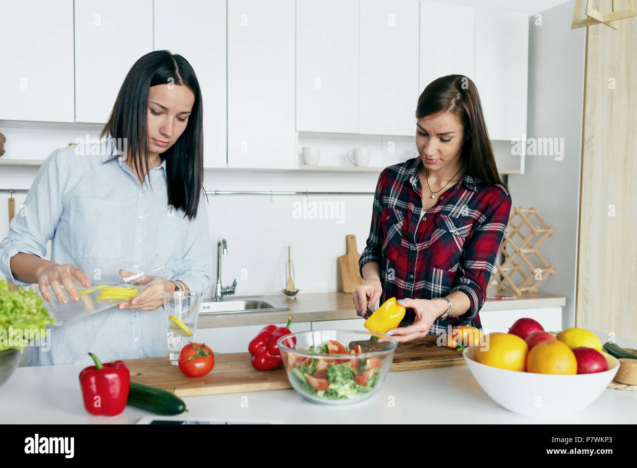 Two friends cooking together home hi-res stock photography and images ...