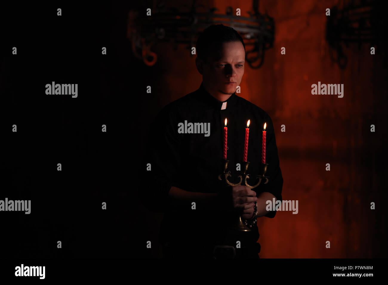 Portrait of handsome catholic priest or pastor with dog collar, dark ...