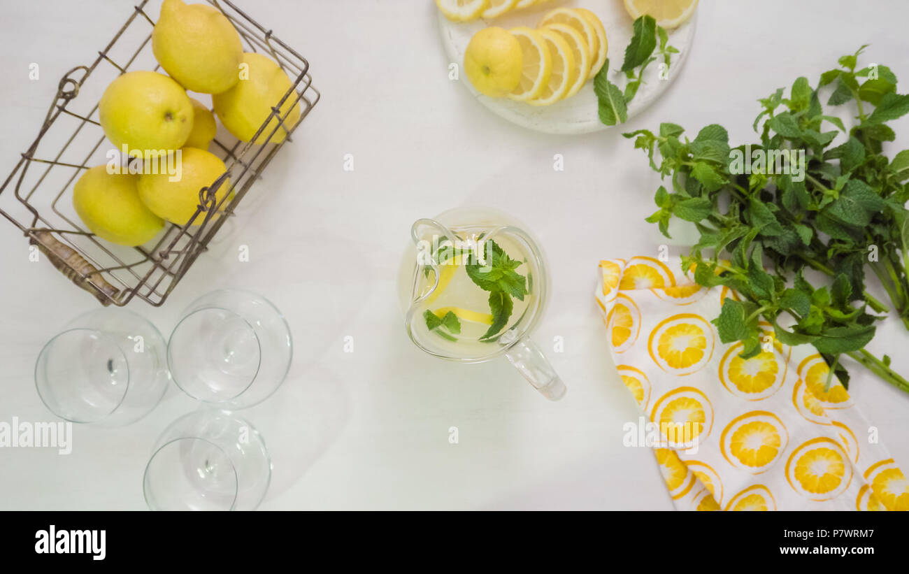 Step by step. Preparing traditional fresh lemonade in glass pitcher ...