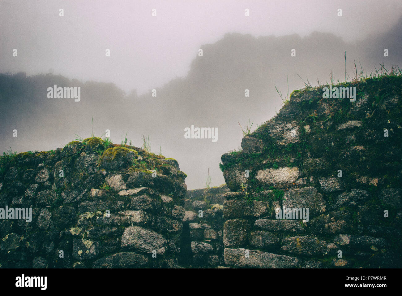 Historical ruins of the ancient Inca civilization covered by fog at ...