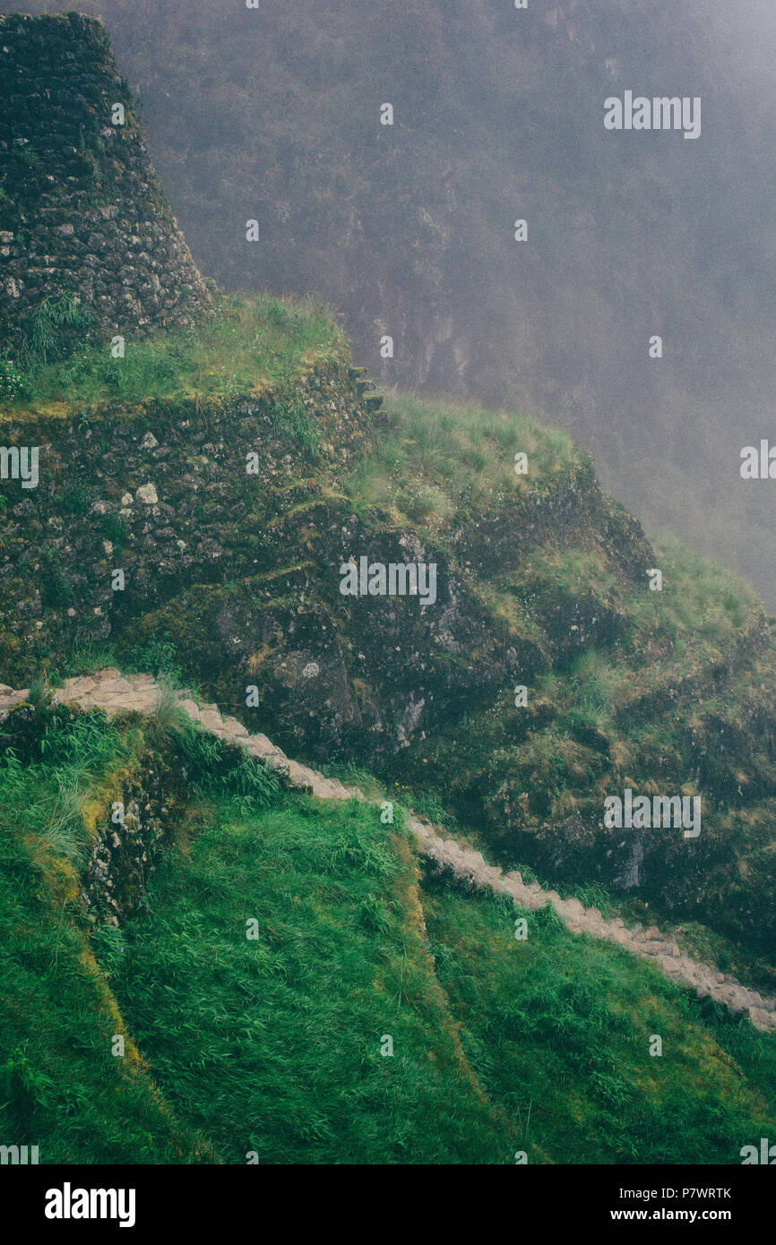 Historical ruins of the ancient Inca civilization covered by fog at ...