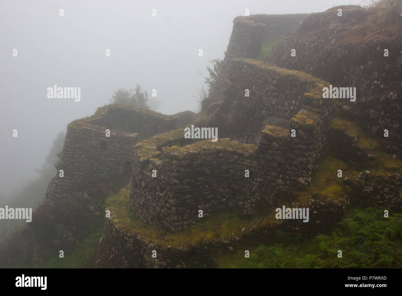 Historical ruins of the ancient Inca civilization covered by fog at ...
