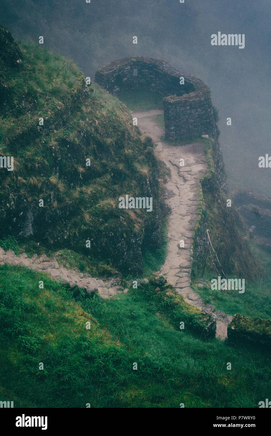 Historical ruins of the ancient Inca civilization covered by fog at ...