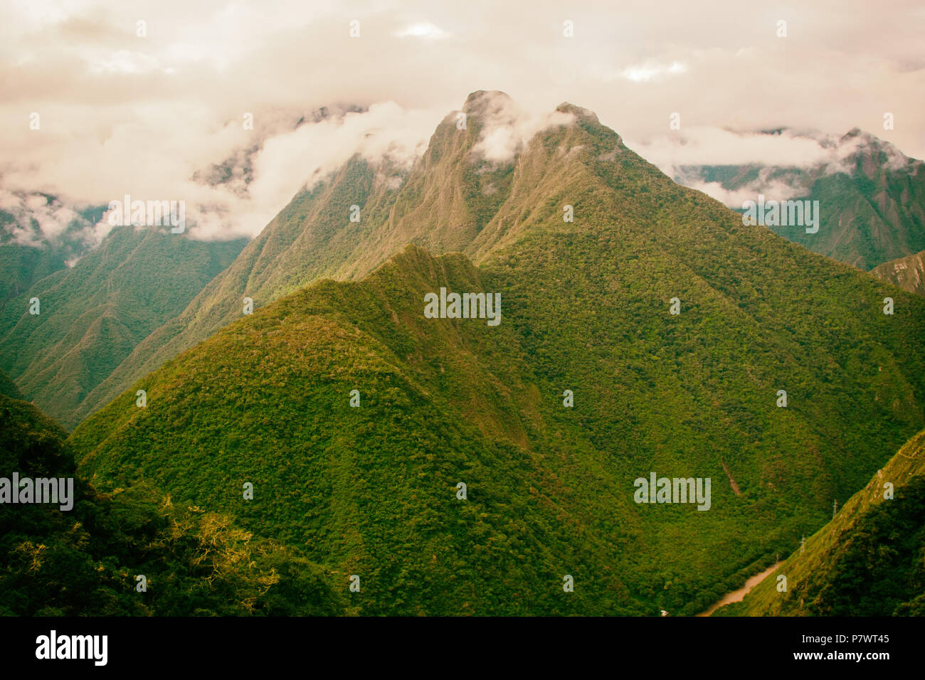 Beautiful wallpaper of the green Andes mountains with clouds above the ...