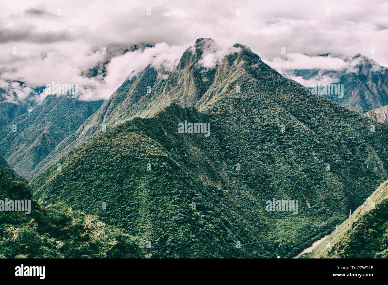Beautiful wallpaper of the green Andes mountains with clouds above the ...