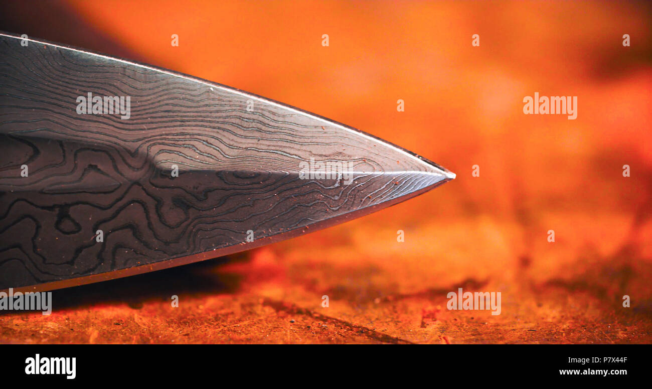 Detail of the tip of a medieval sword on red background Stock Photo - Alamy