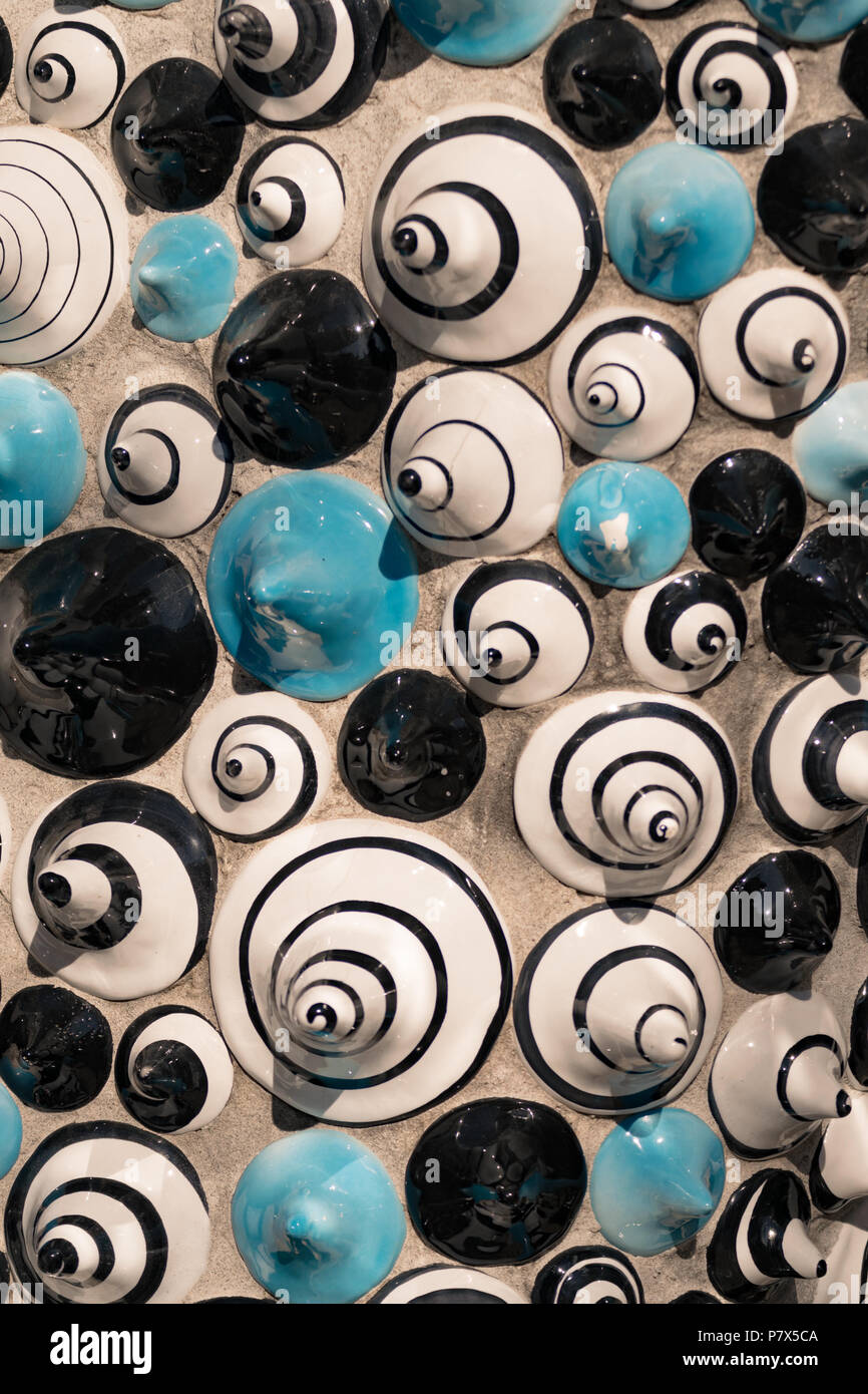 Texture of ceramic in the shape of cones painted with figures of ...