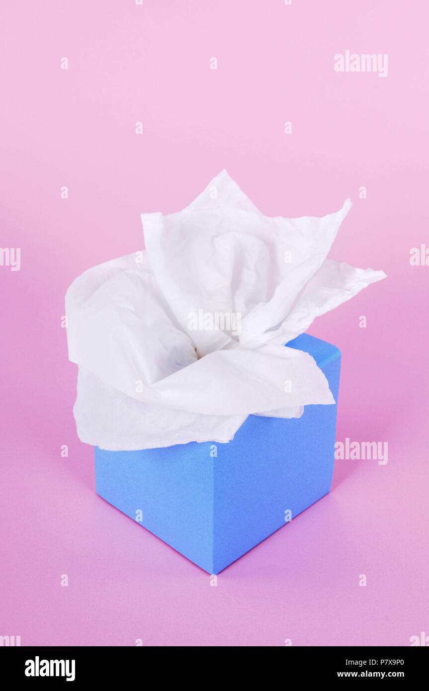Kleenex style tissues in blank blue box on a pink background Stock ...