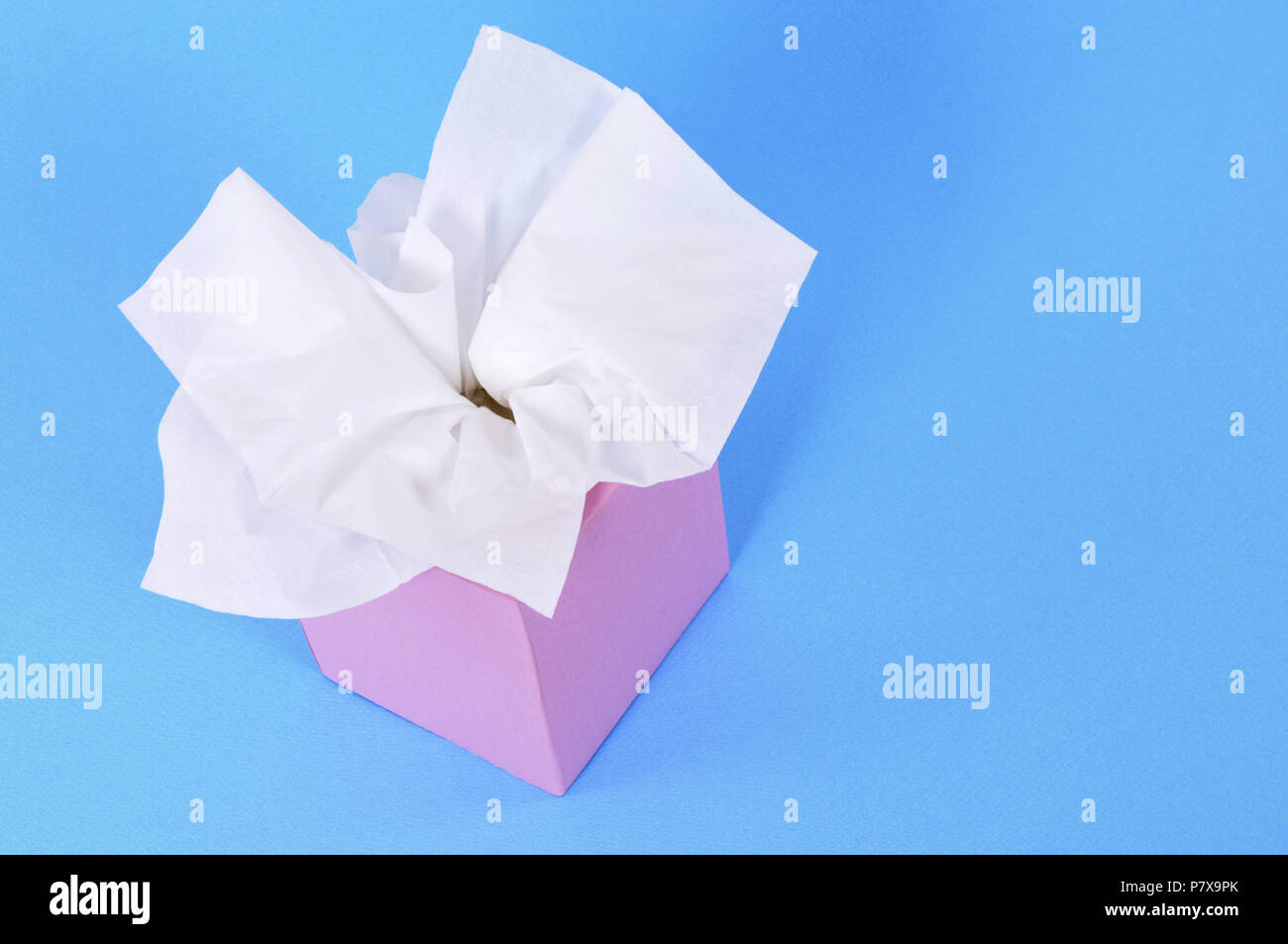 Kleenex style tissues in blank pink box on a blue background Stock ...