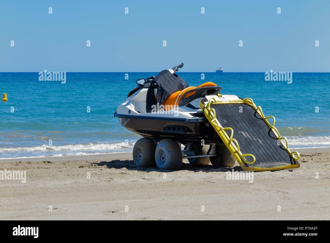 horizontal view of a beach scene in a sunny day with a rescue jet ski ...