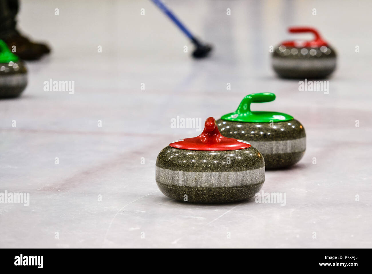 Granite stones for curling game on the ice Stock Photo - Alamy