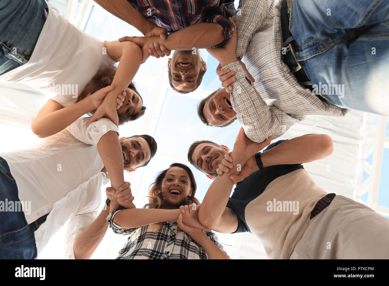 Happy group of businesspeople stacking their hands in cooperation Stock ...