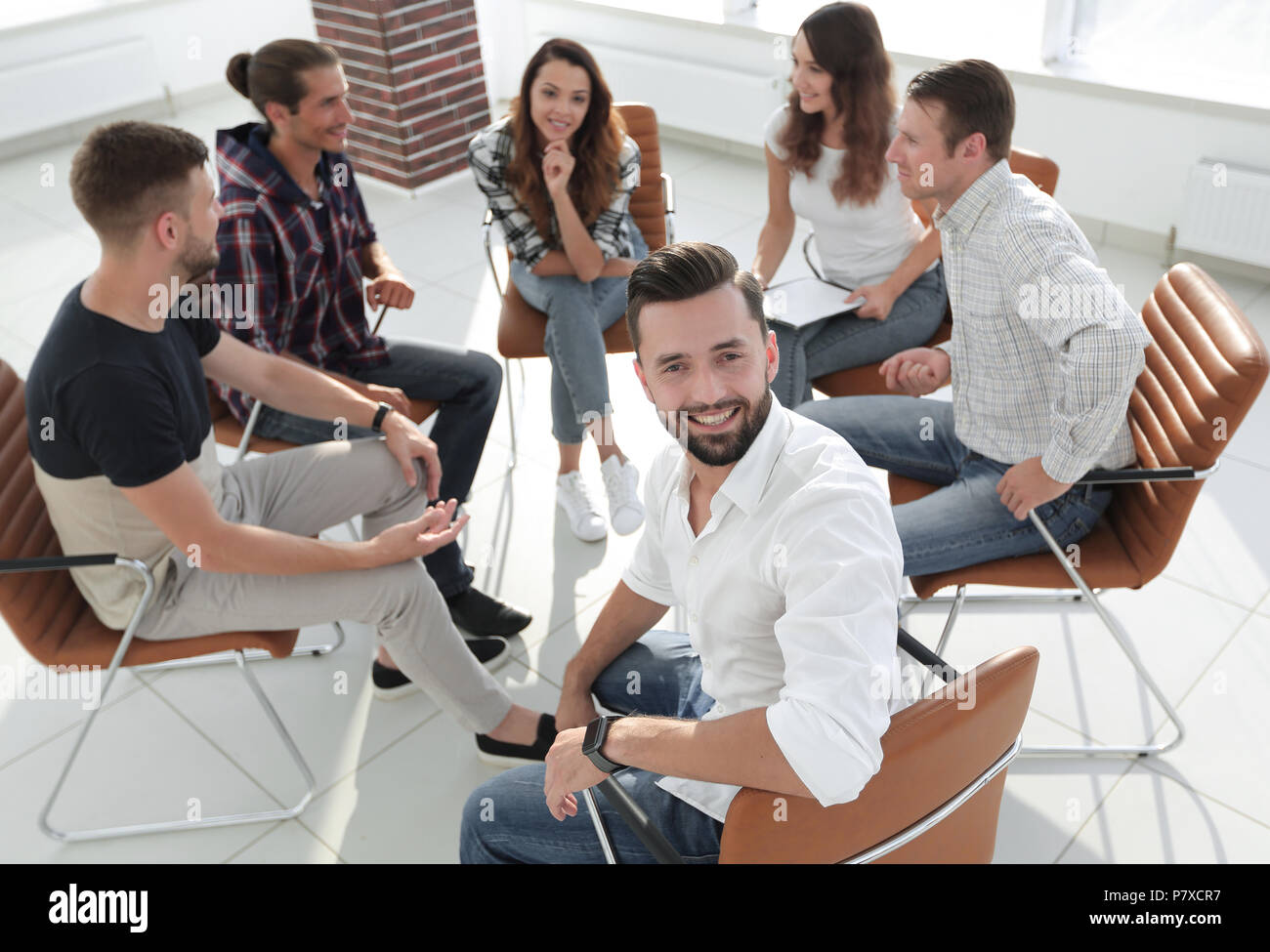 Manager and his team sitting in the office Stock Photo - Alamy