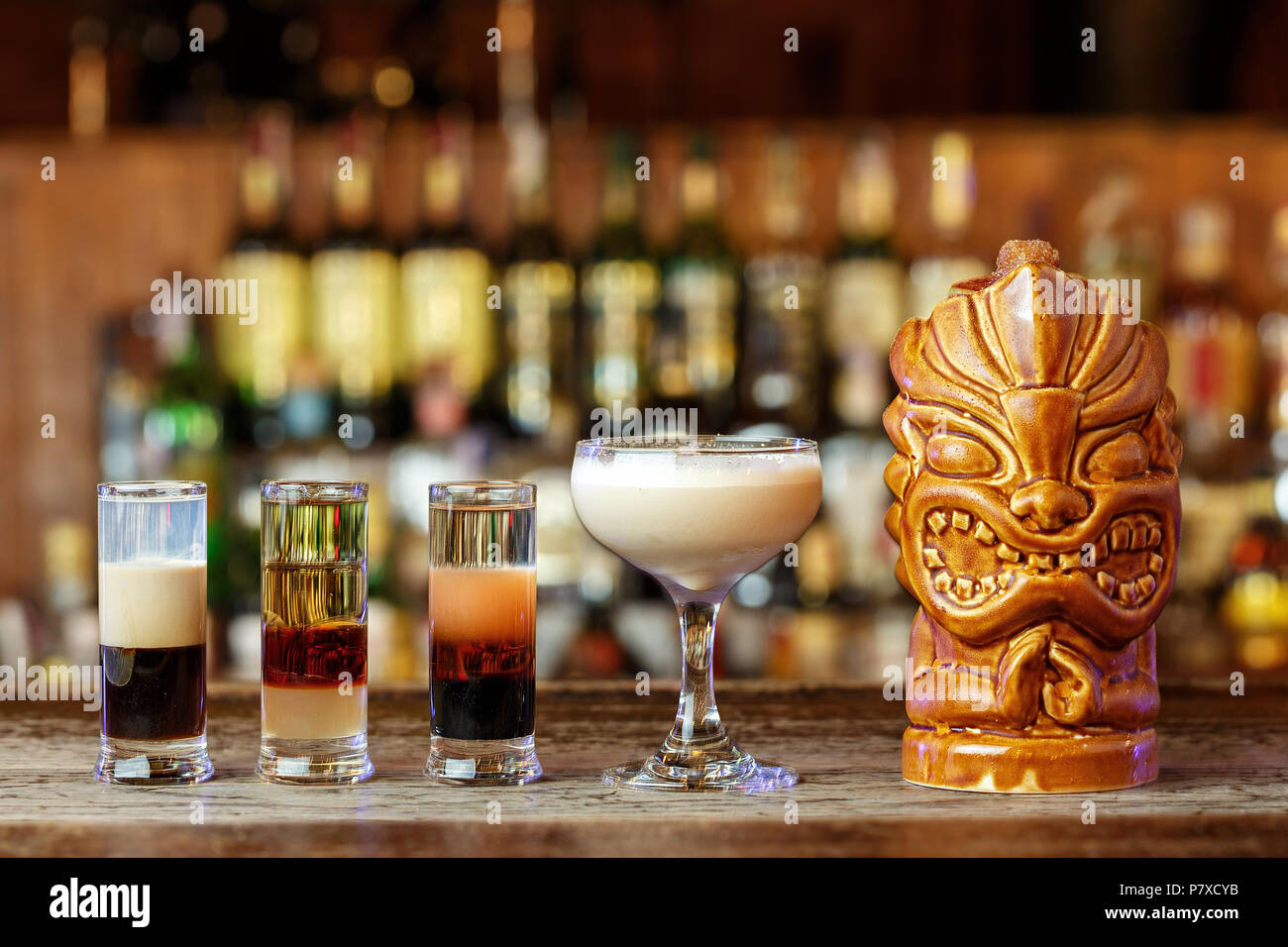 different club cocktails for men and women in different glasses stand ...