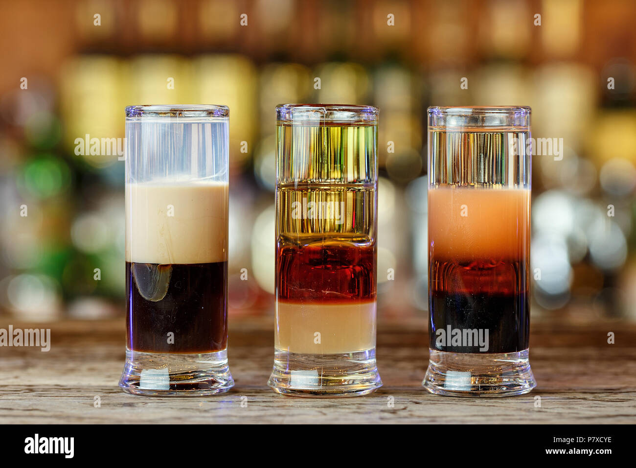 Different club cocktails in different glasses stand on a bar counter on ...