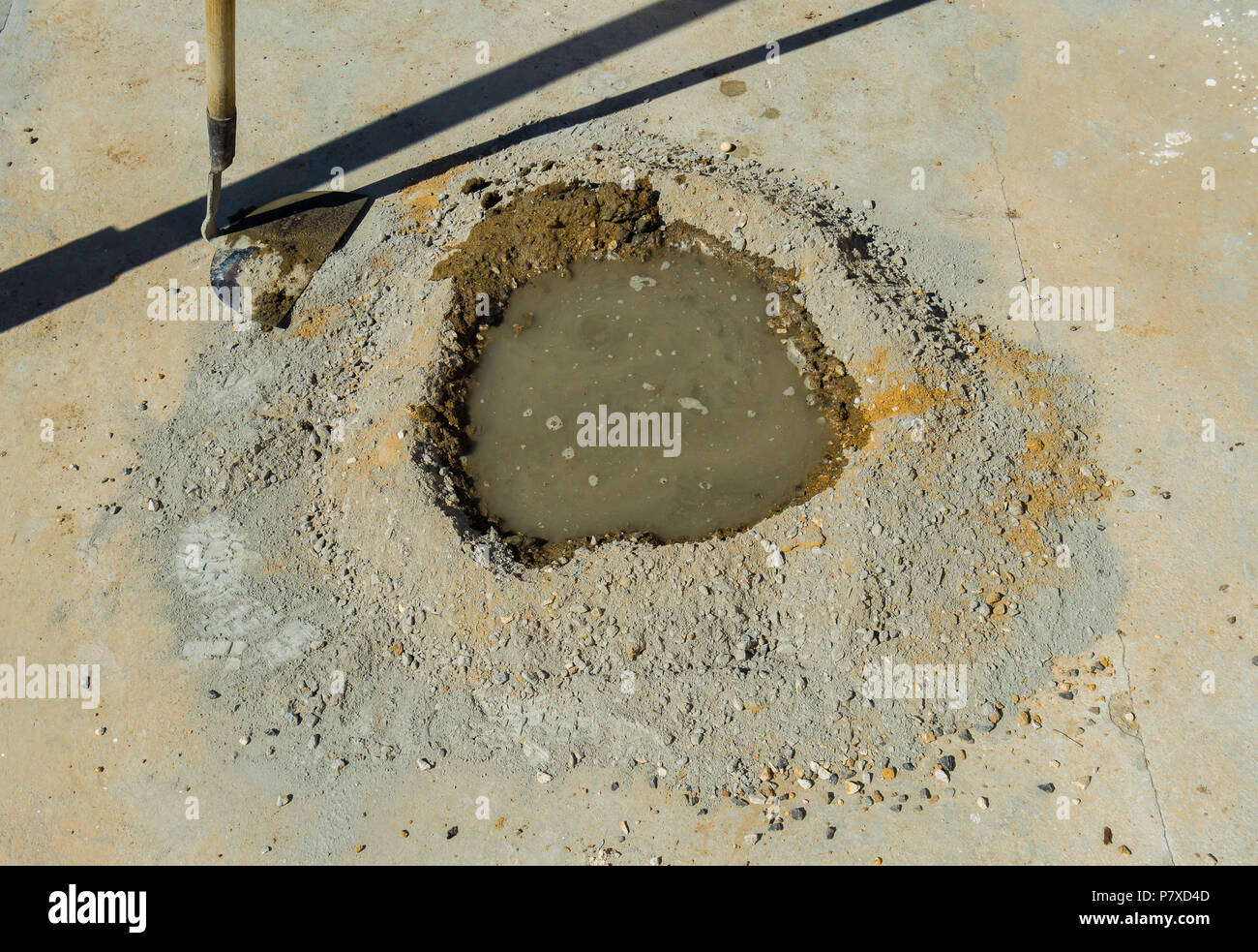 Making cement with sand, water and cement. Mixing materials with a hoe ...