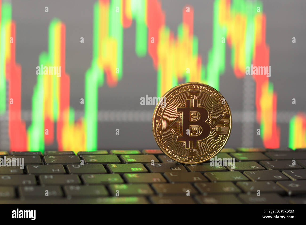 Bitcoin close-up and a graph of growth and fall in prices Stock Photo ...