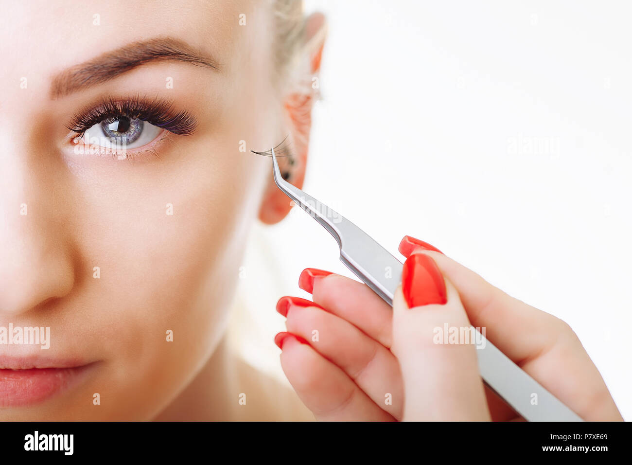 Eyelash Extension Procedure. Woman Eye with Long Eyelashes. Close up ...