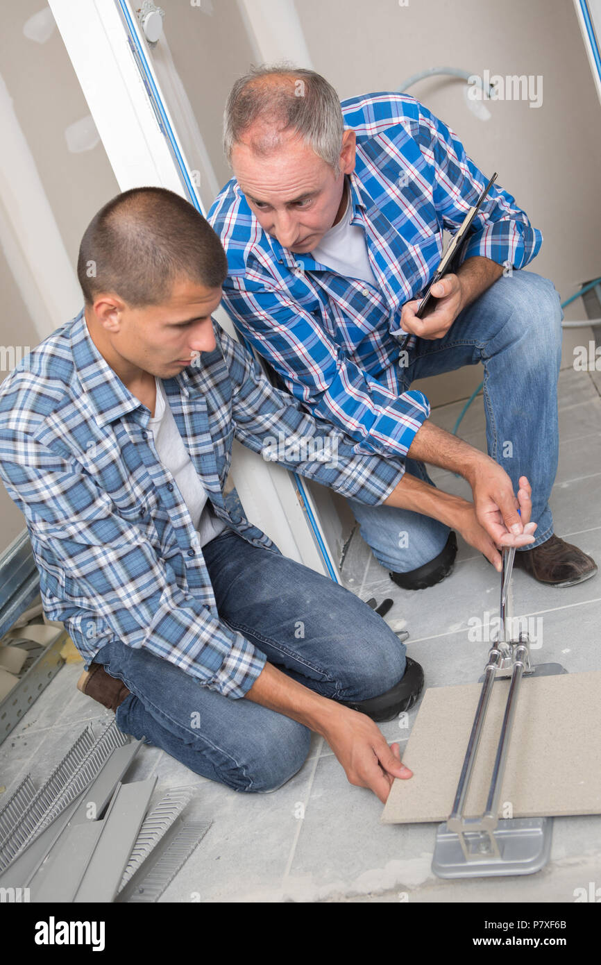 tile cutting worker working with floor tile cutting Stock Photo - Alamy