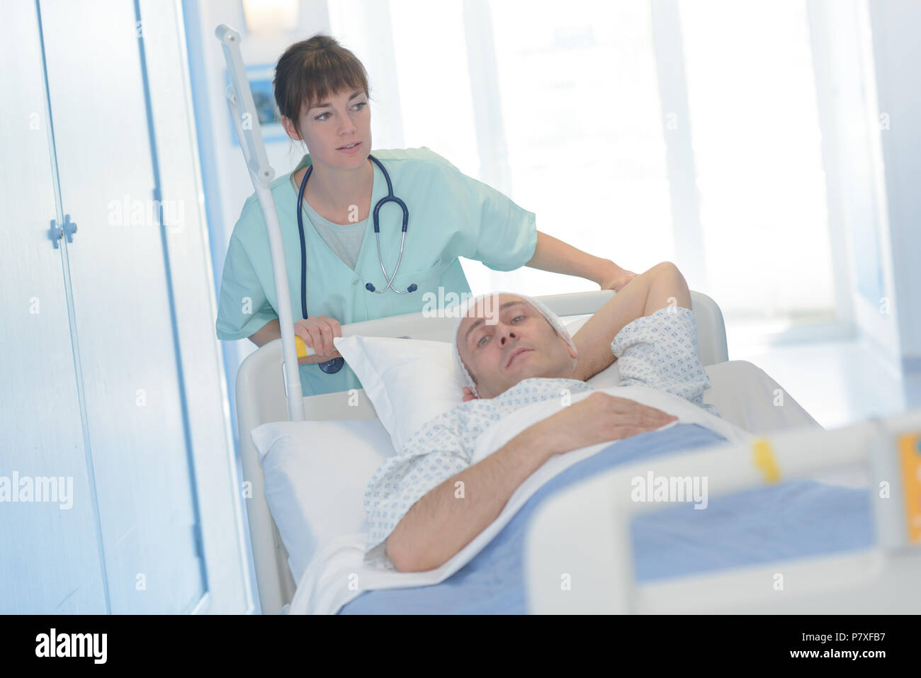 pretty doctor transporting a patient laying on a stretcher Stock Photo ...