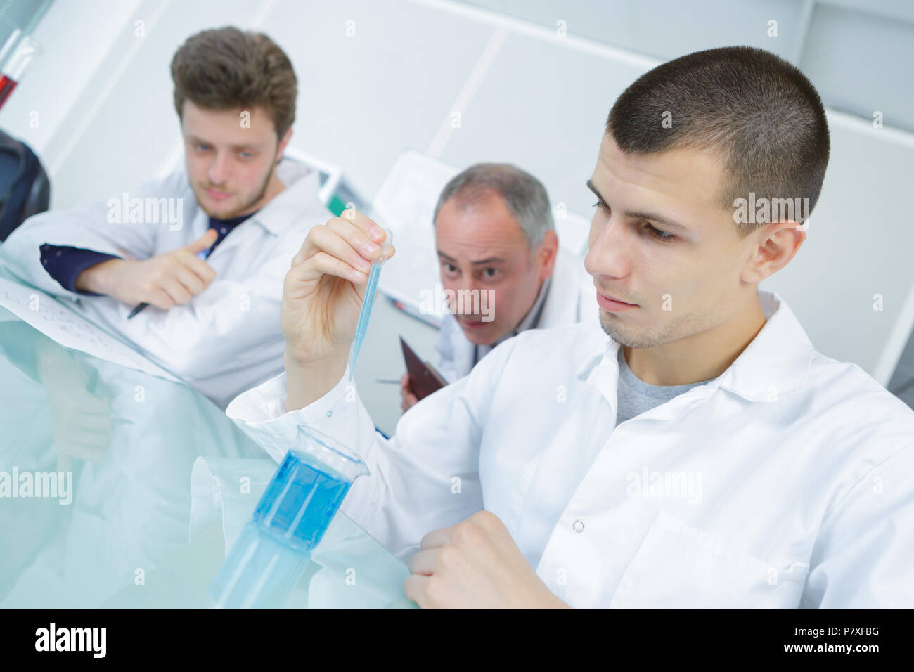 young scientist observing liquid reagent in laboratory Stock Photo - Alamy