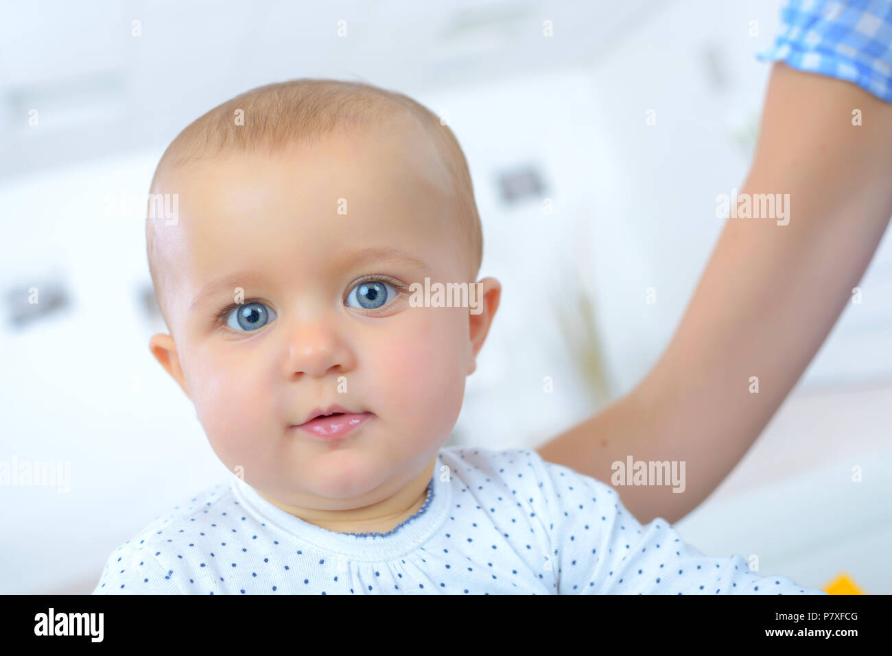 cute baby face smiles looking up at the camera Stock Photo - Alamy