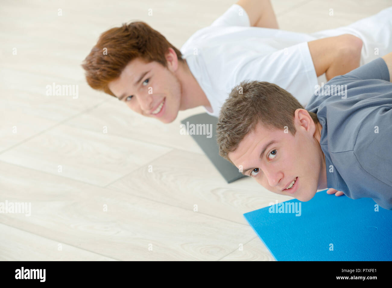 two young men in gym working out Stock Photo - Alamy