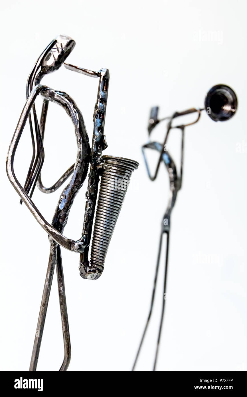 Figures of music performers made with welded black metal wire. Two ...