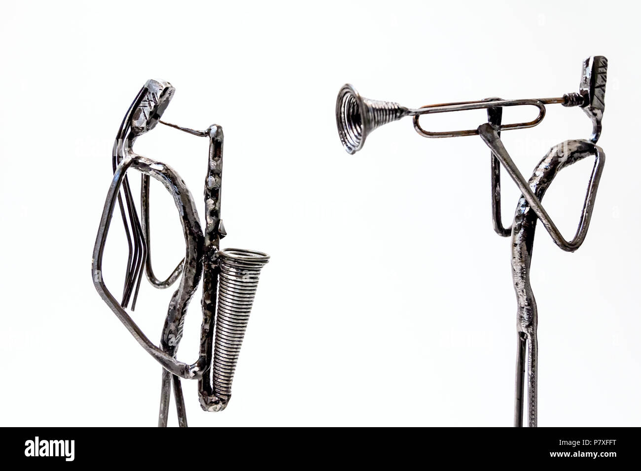 Figures of music performers made with welded black metal wire. Two ...