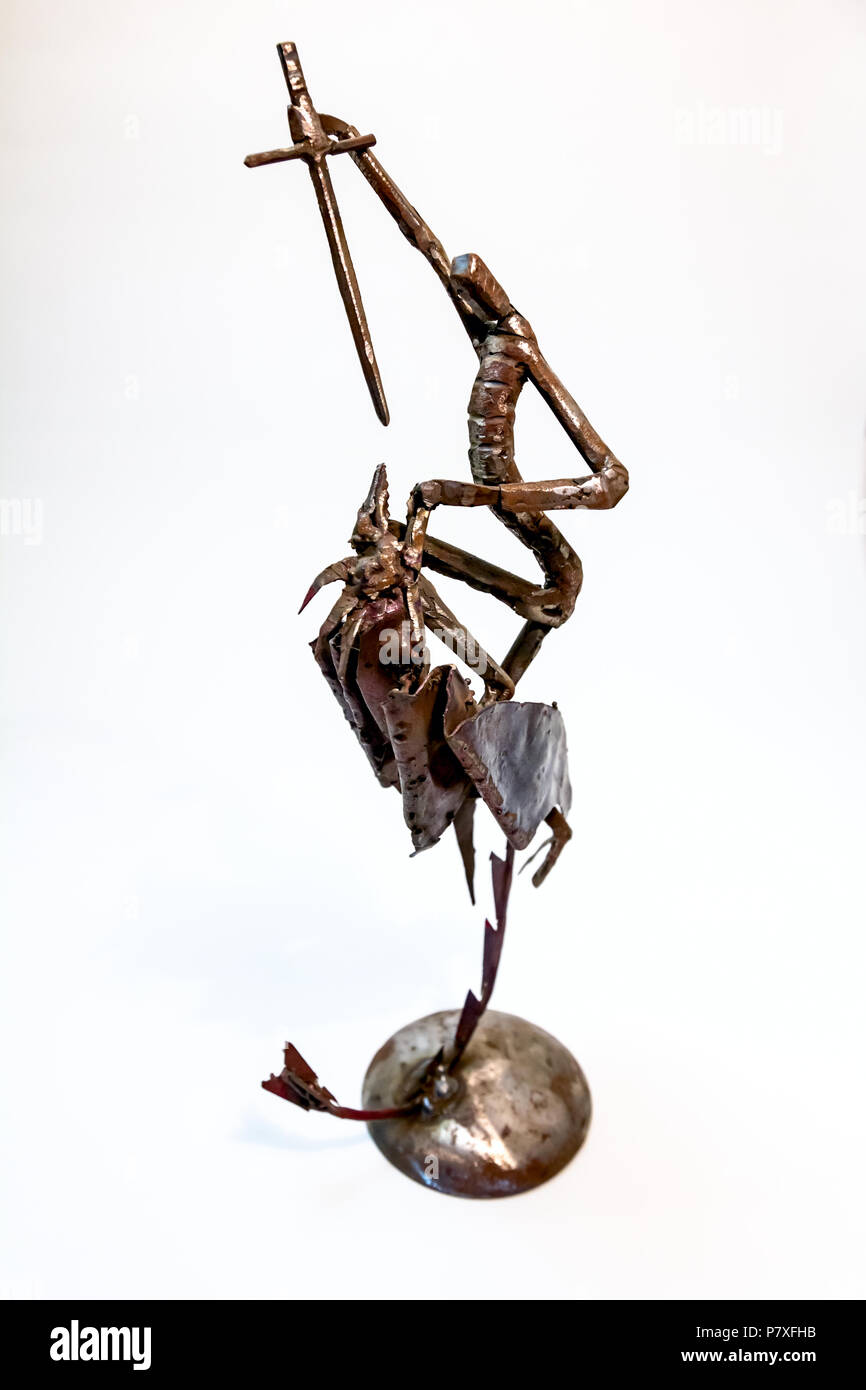 Knight Saint George is waving with his sword as he killing the dragon ...