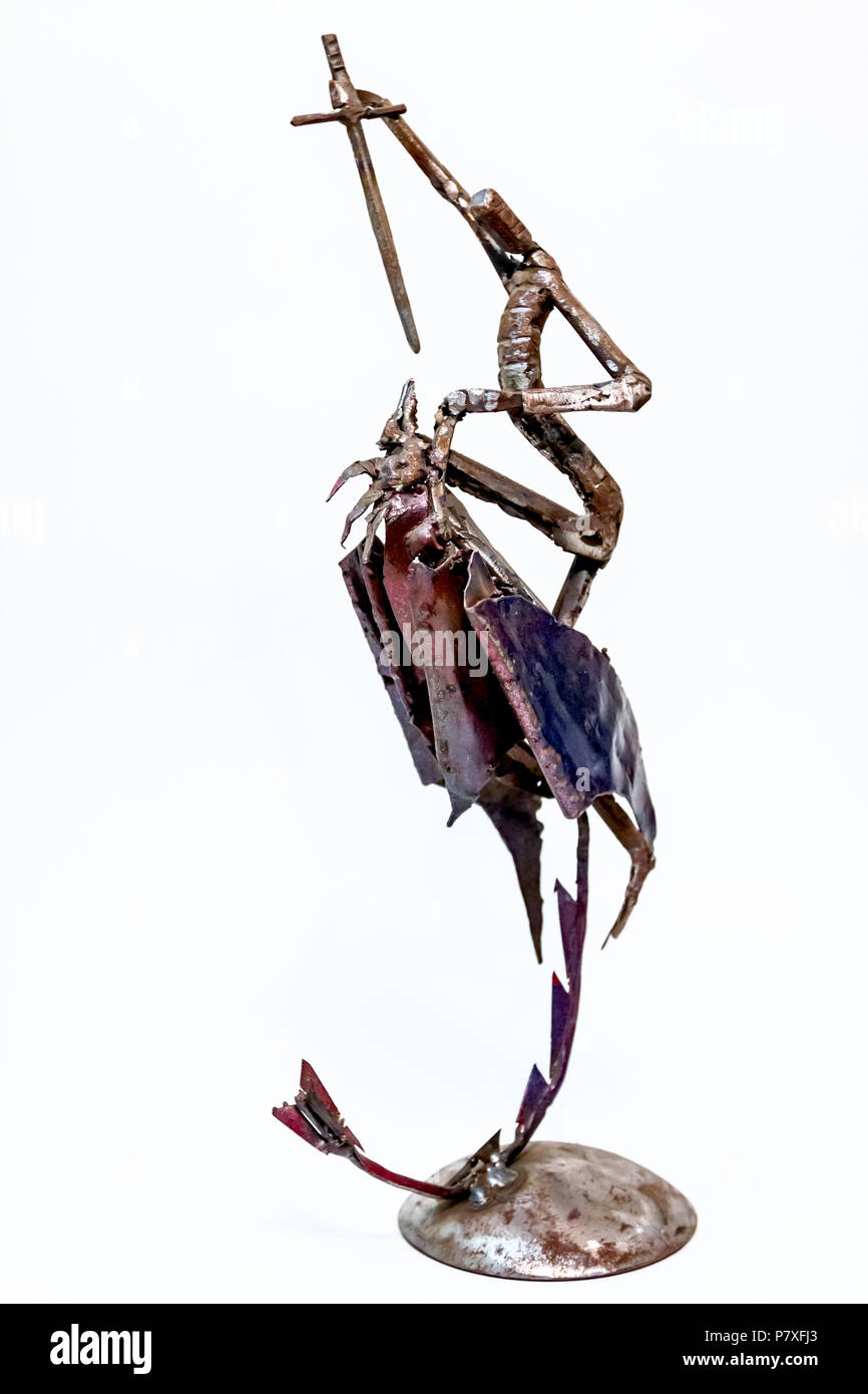 Knight Saint George is waving with his sword as he killing the dragon ...