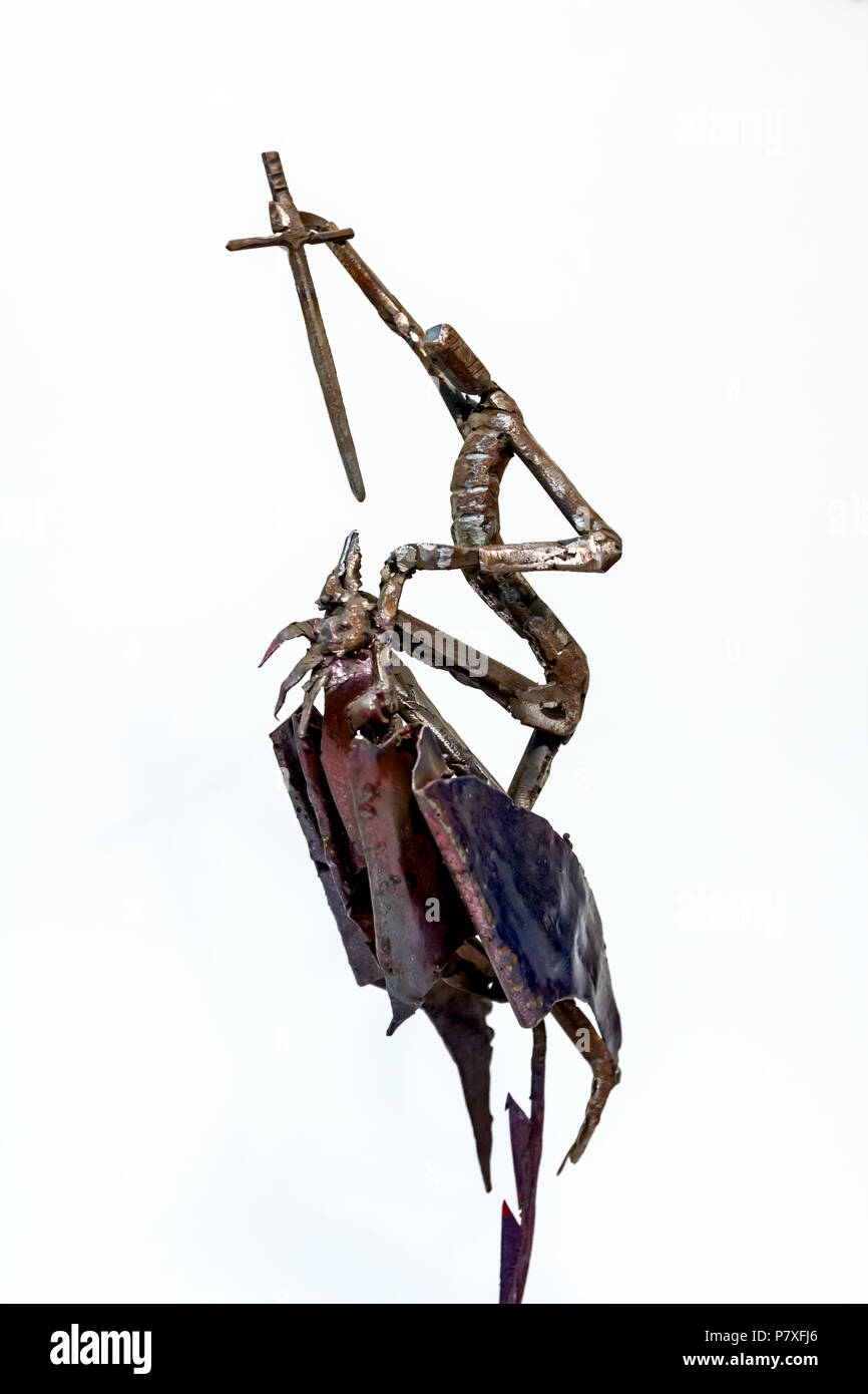 Knight Saint George is waving with his sword as he killing the dragon ...