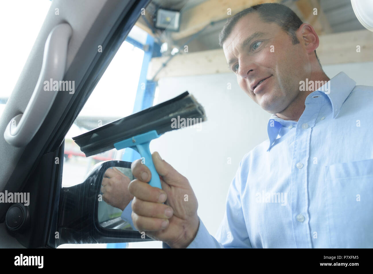 adult man washing dirty windshield of his car Stock Photo - Alamy