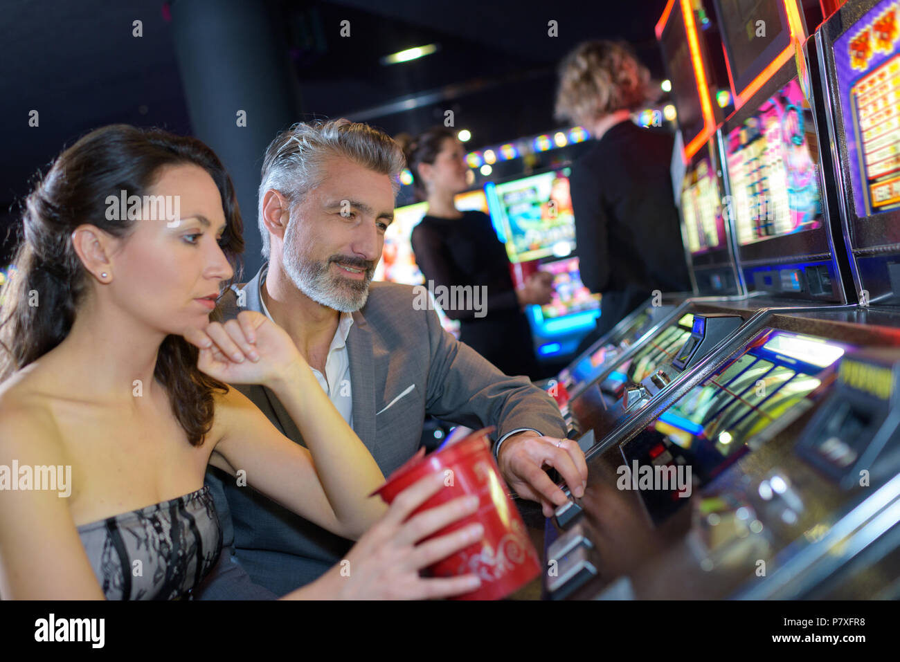 Man and woman playing gaming machine hi-res stock photography and ...