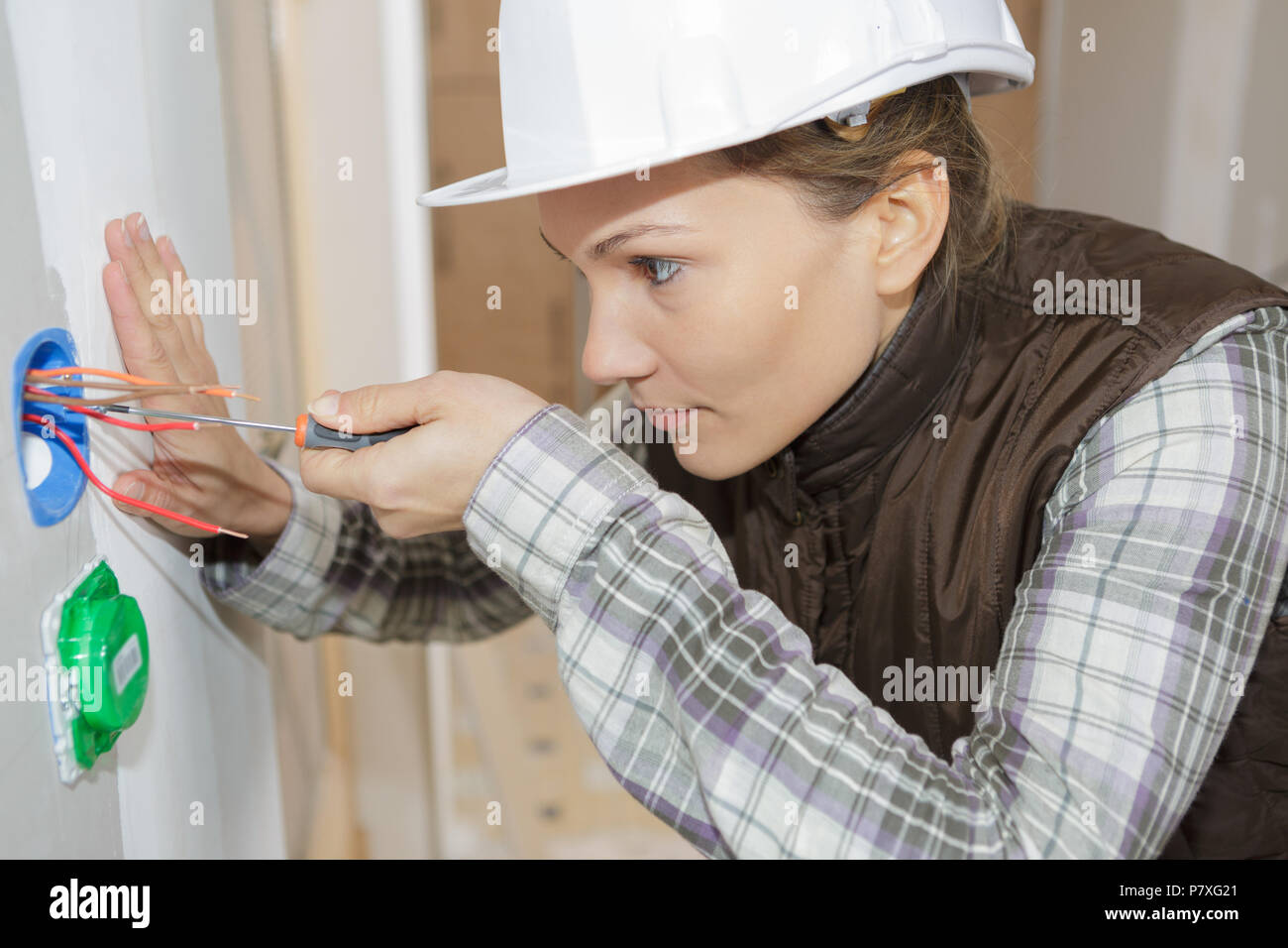 female electrician fixing socket electricity problem Stock Photo - Alamy