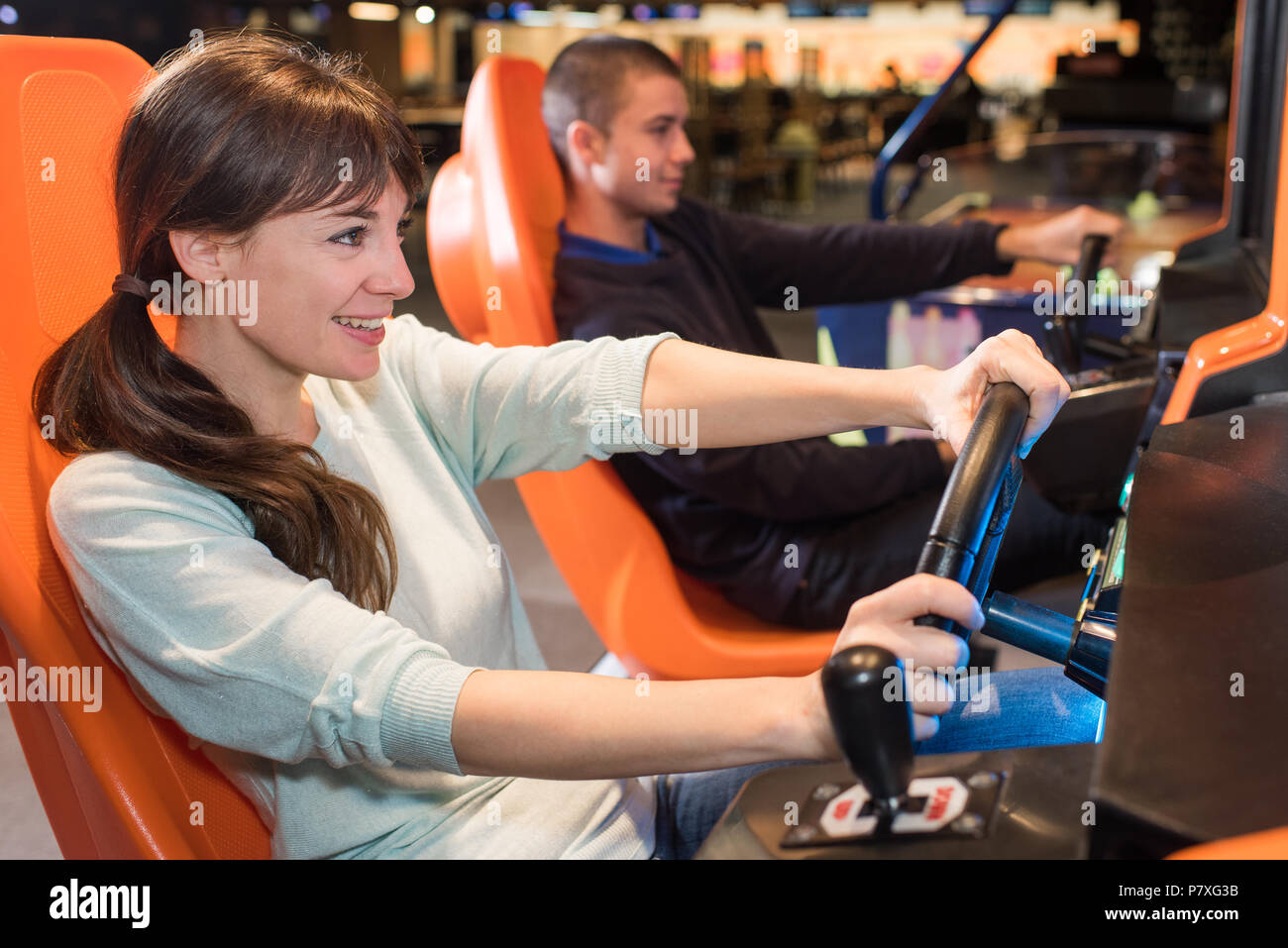 young people at wheel of arcade games Stock Photo - Alamy