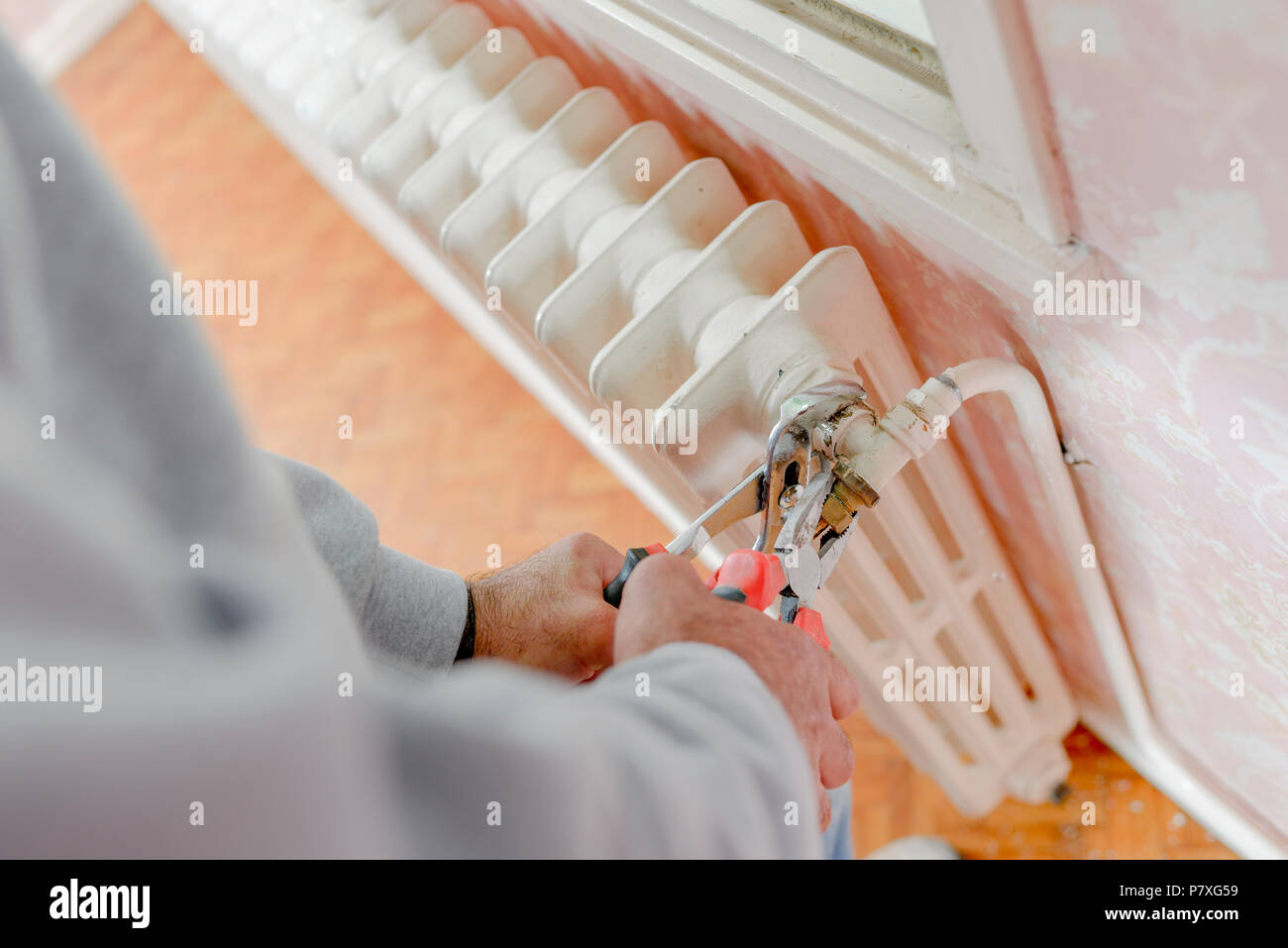Fixing a radiator Stock Photo - Alamy