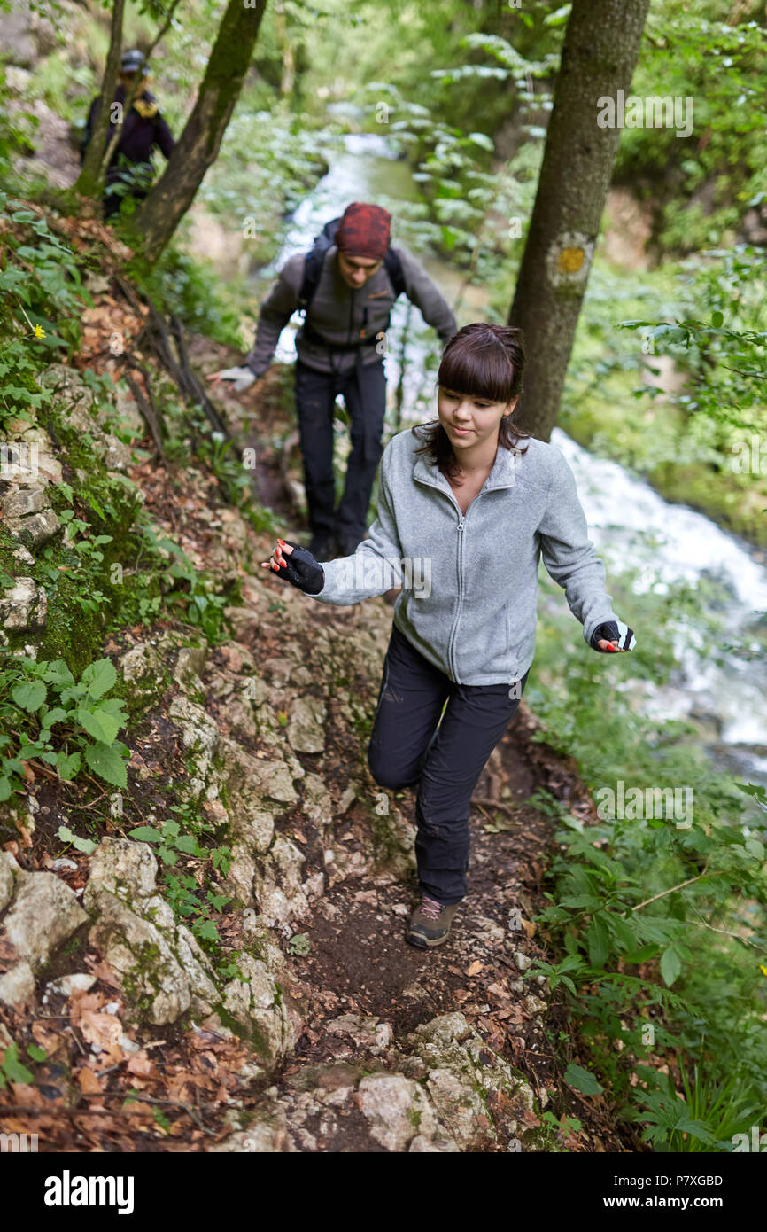 Group of people hiking on a trail in the mountain forest Stock Photo ...
