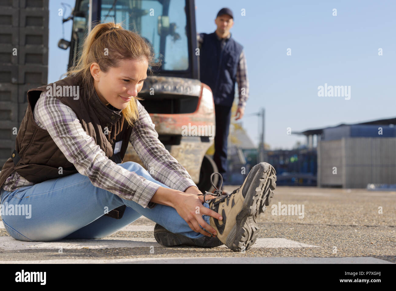 female colleague lying on the floor oustide the warehouse Stock Photo ...